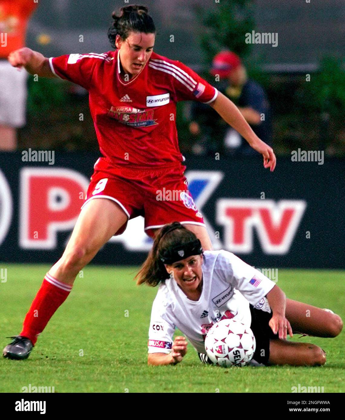 American All-Stars' Joy Fawcett goes to the ground as she battles World ...