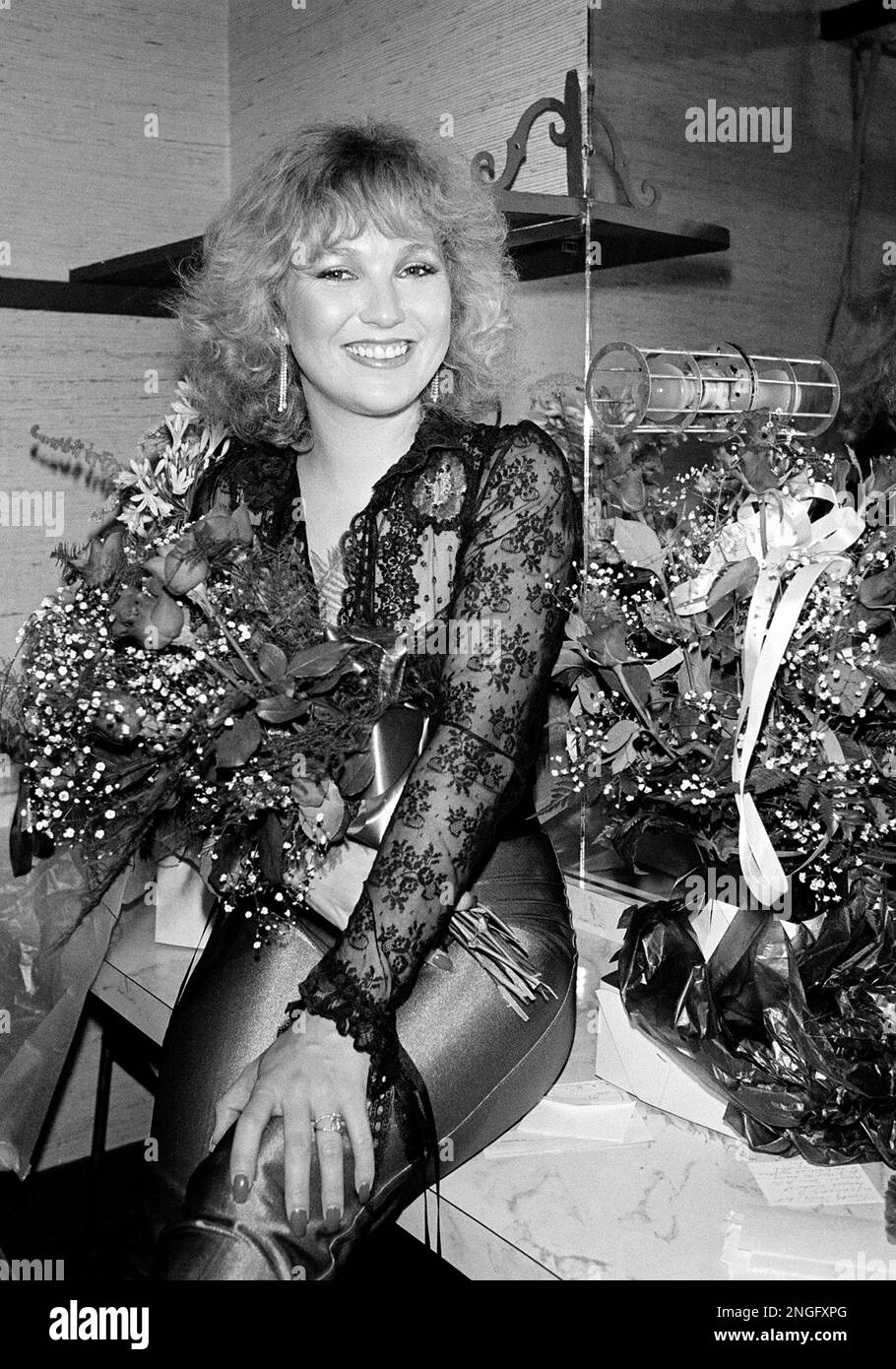 Country singer Tanya Tucker holds a bouquet of roses in her dressing ...