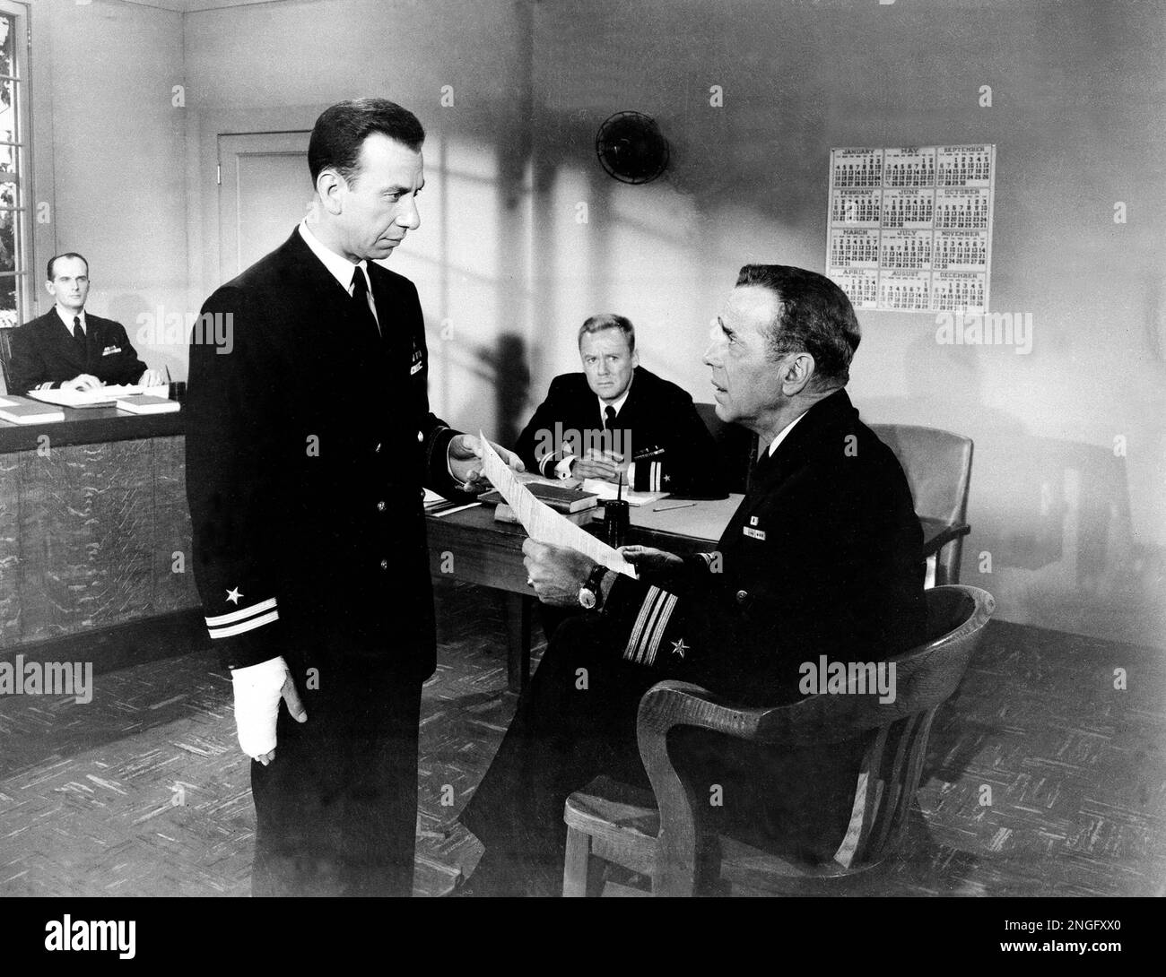 Jose Ferrer, left, portraying Lt. Barney Greenwald, Van Johnson, center ...