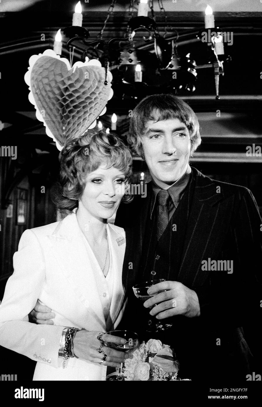 Actor Peter Cook and actress Judy Huxtable pose with champagne glasses ...