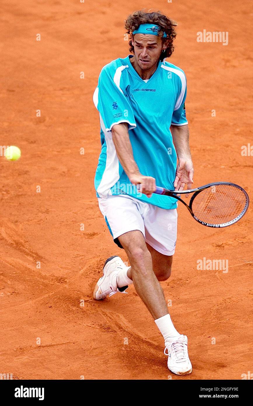 15th-seeded Gustavo Kuerten of Brazil returns a forehand during a ...
