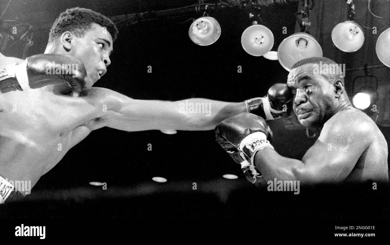 Challenger Cassius Clay throws a straight left to the face of Charles ...