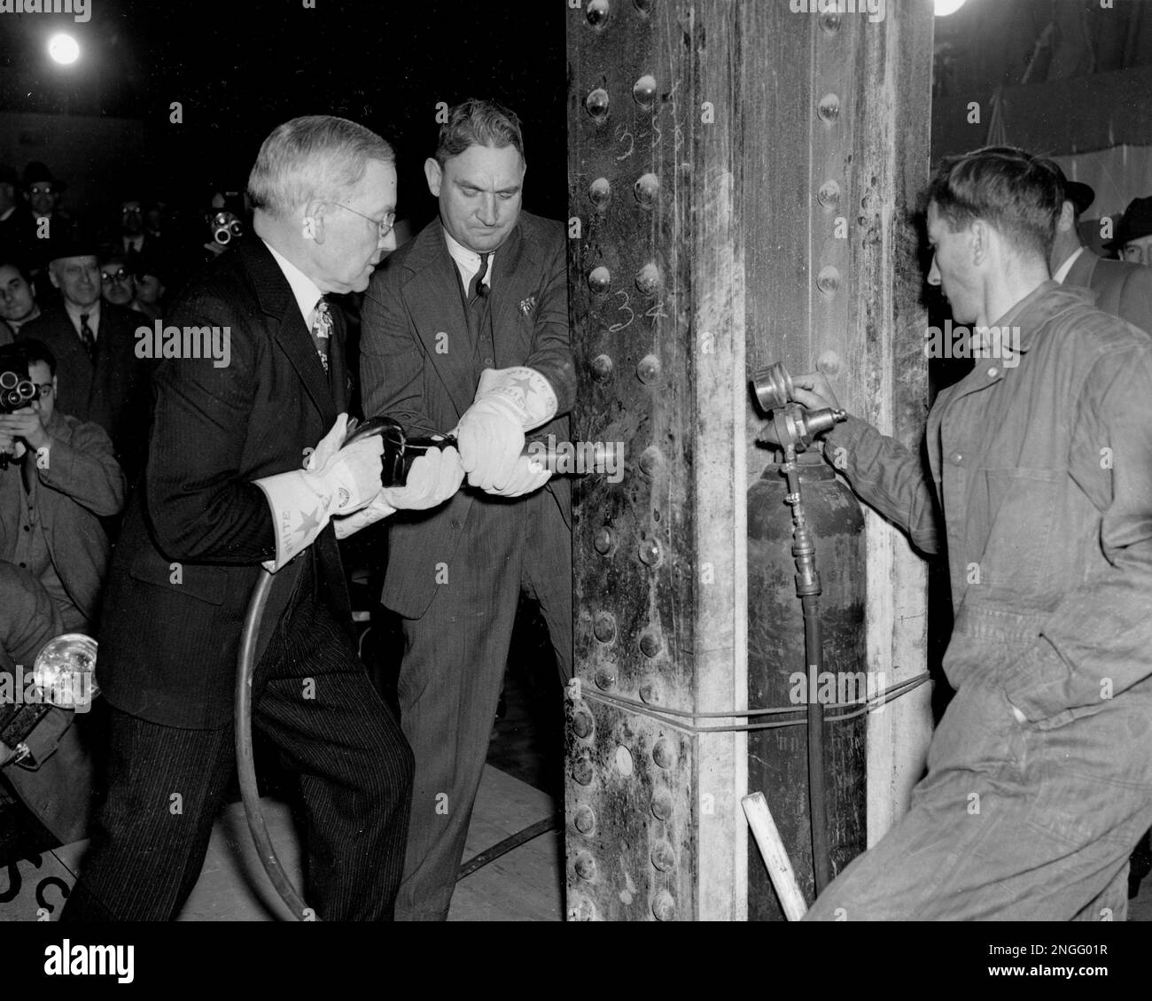 John D. Rockefeller Jr., drives the last rivet into the steel beam of ...