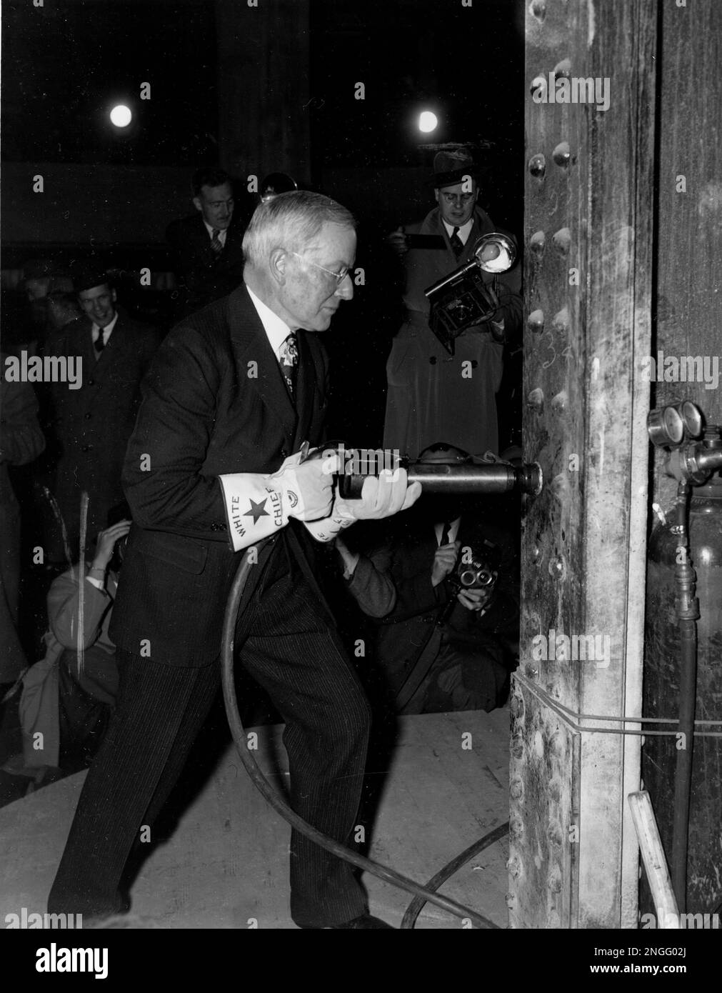 John D. Rockefeller Jr., hammers the last rivet into the steel beam of ...