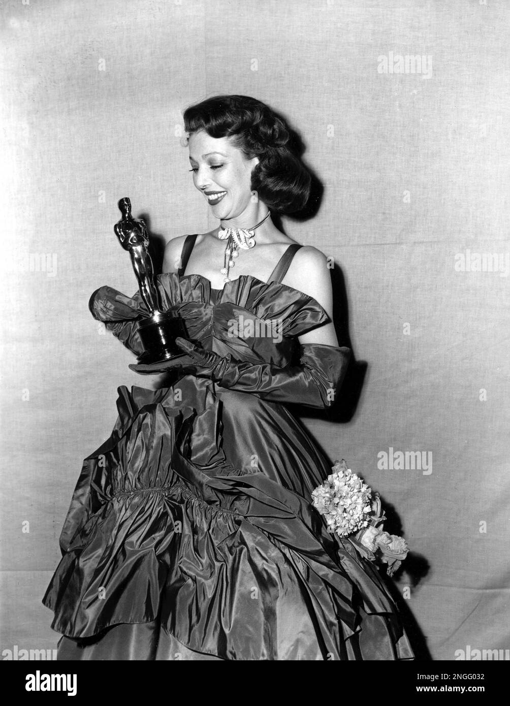 Loretta Young looks at her Oscar at the 1947 Academy Awards held at the ...