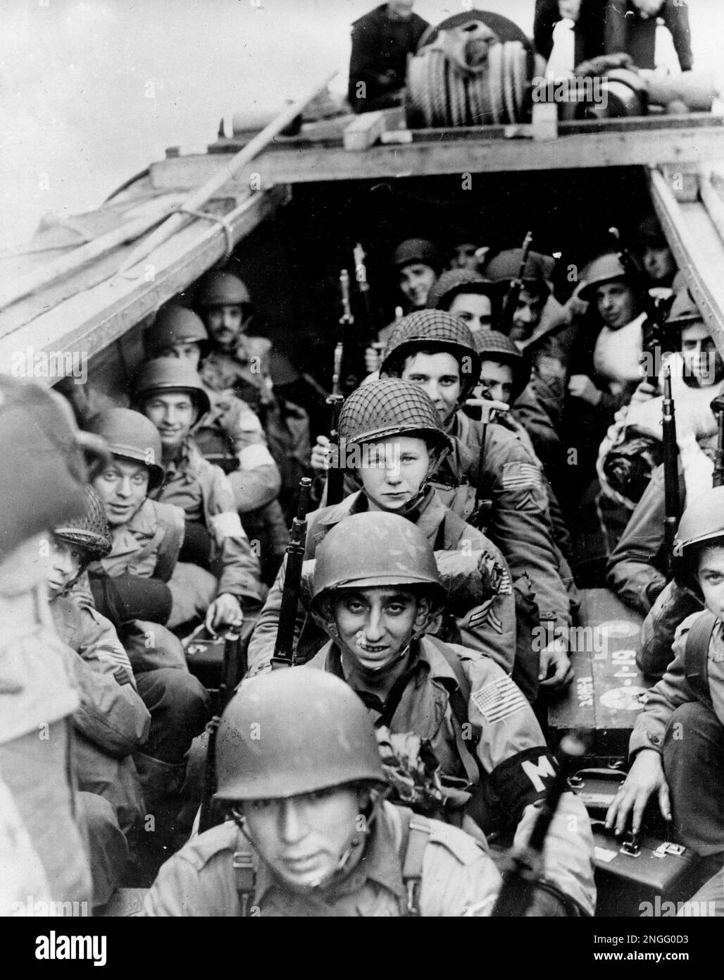 American soldiers look up from a landing barge during their amphibious ...