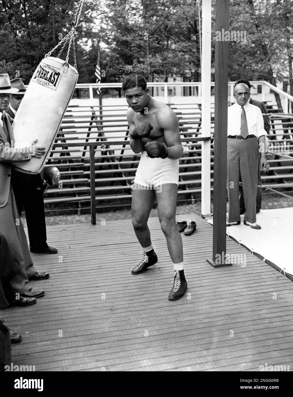 Heavyweight boxer Joe Louis works out with the punching bag in Lakewood ...