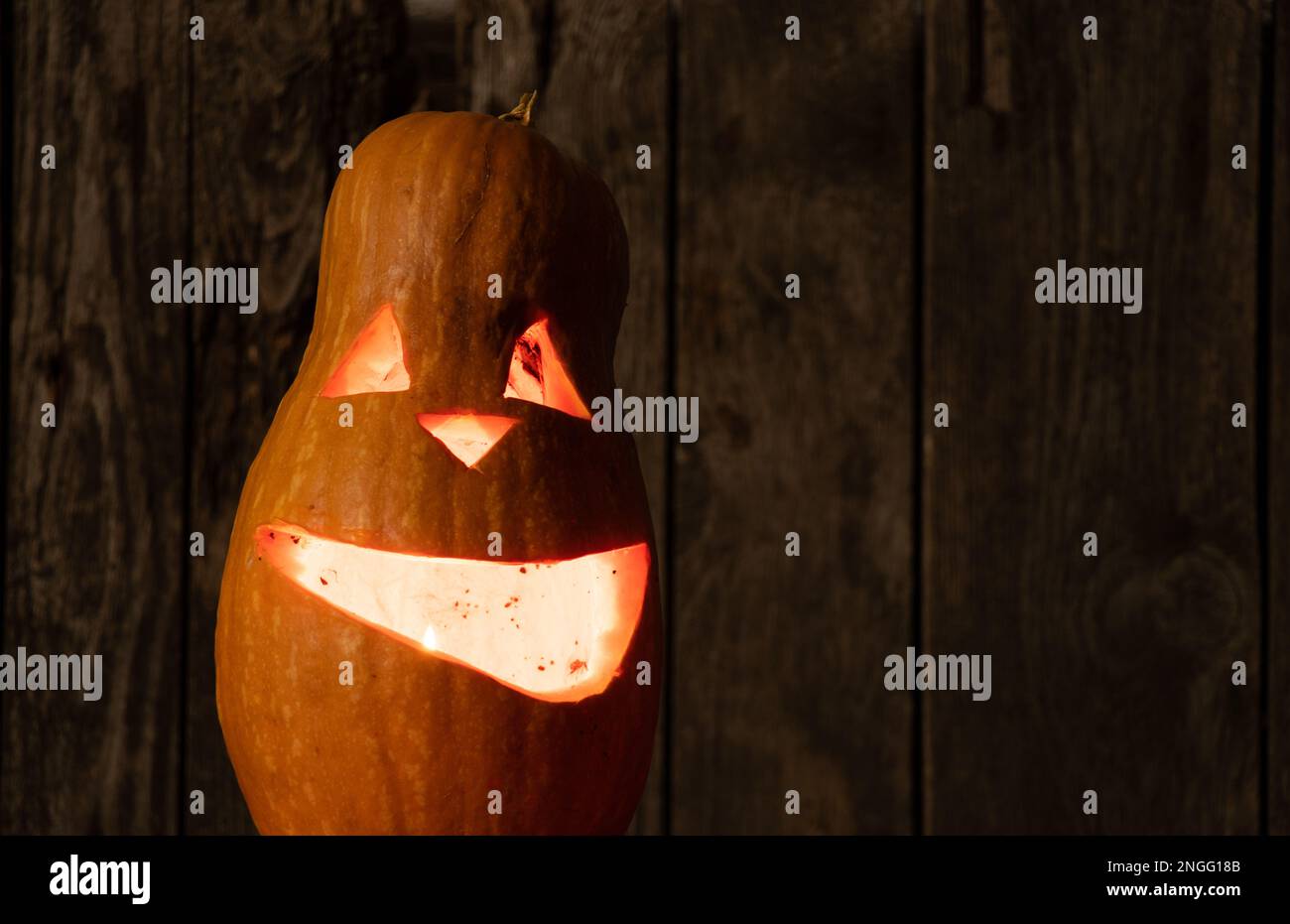 Halloween pumpkin smile and scary eyes for a party. Close up view of ...