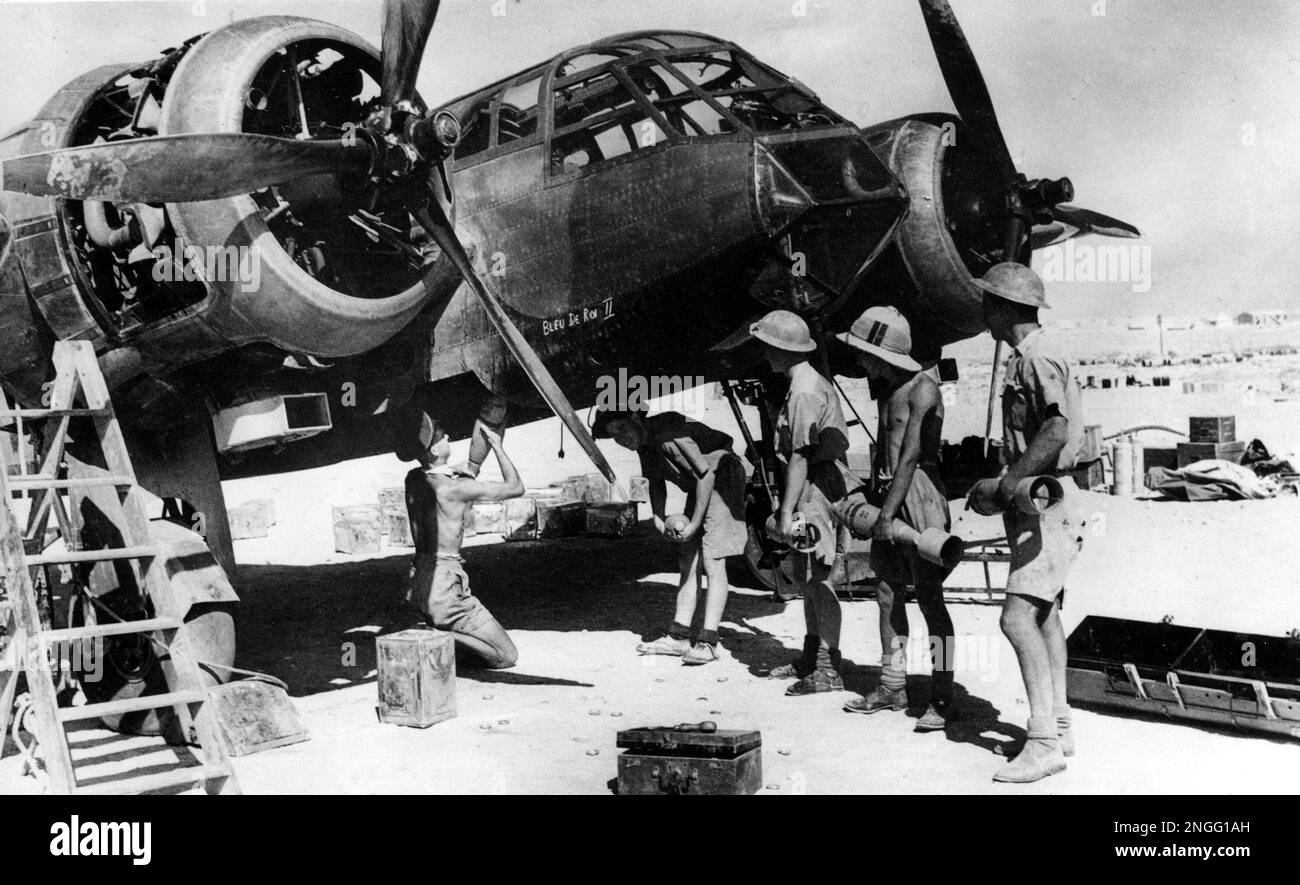 A British desert raider is loaded with small bombs, to be dropped on ...