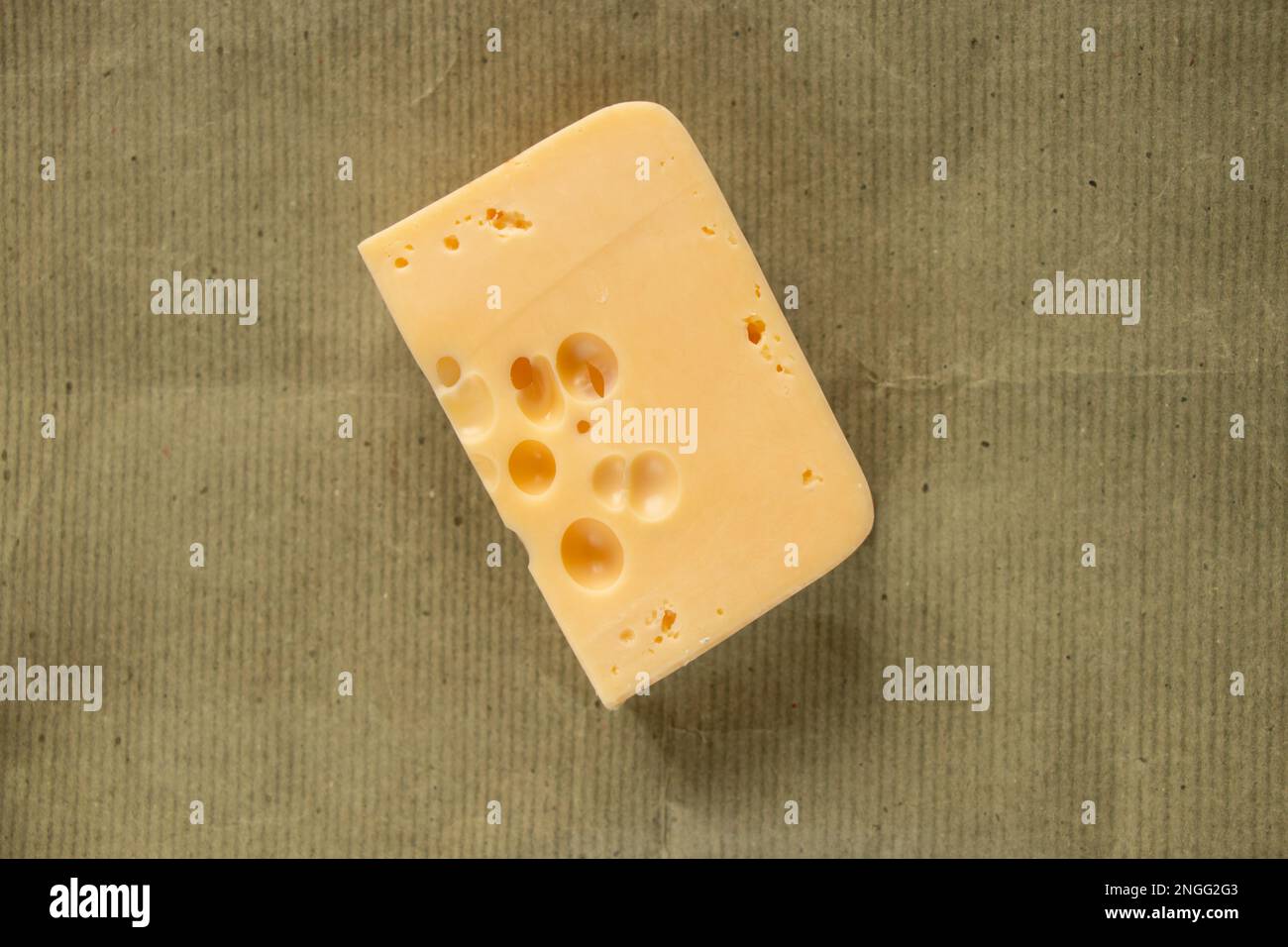 piece of cheese with holes on isolated background close up Stock Photo ...