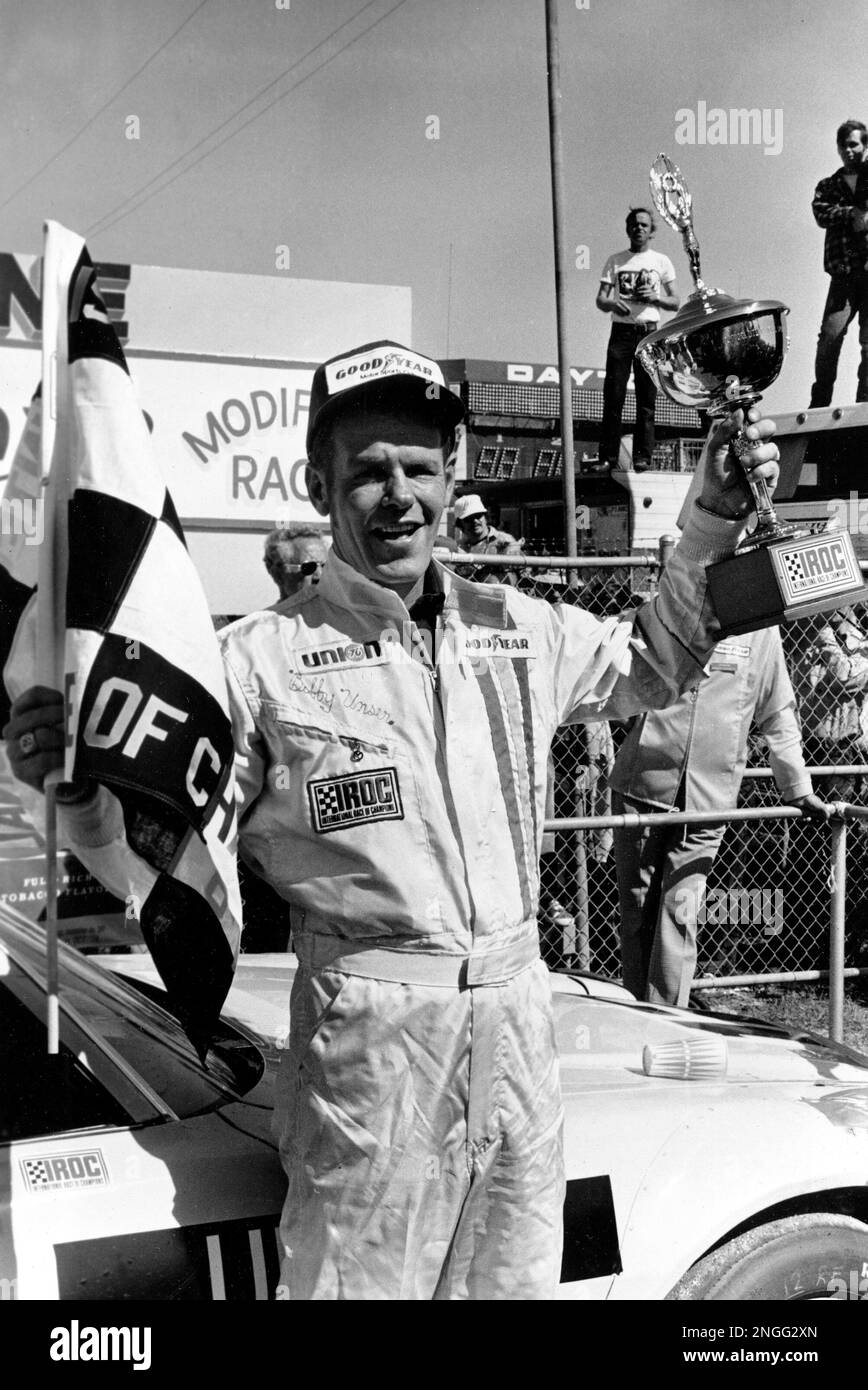 Bobby Unser poses with his trophy in victory lane, after he won the ...