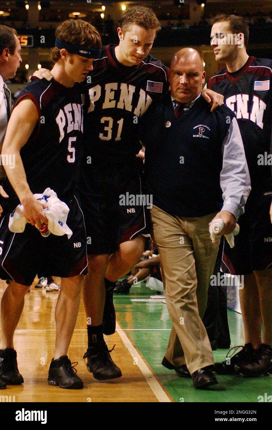 Penn player Tim Begley (31) is helped off the court by teammate Charlie ...