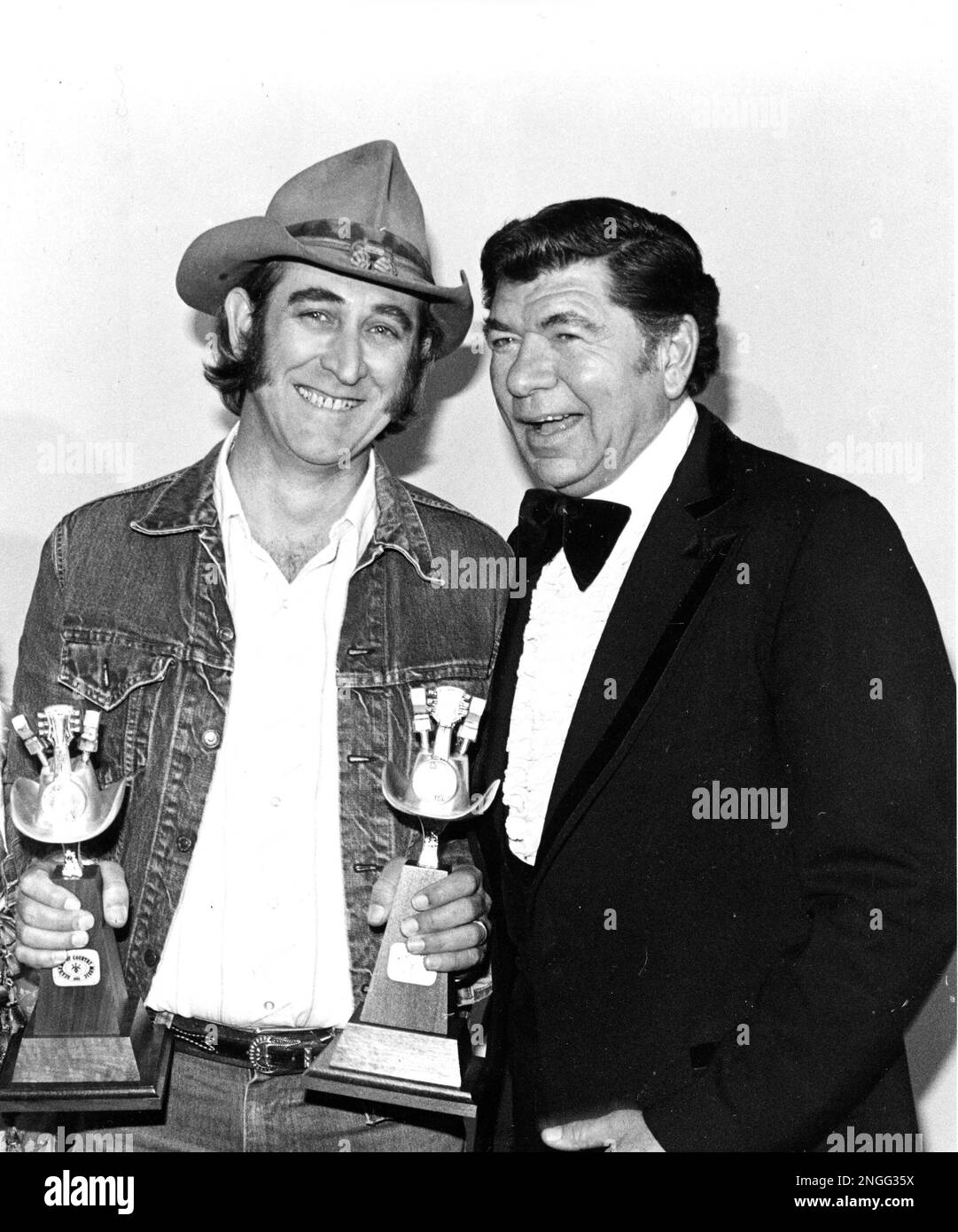 Country singer Don Williams, left, poses with two awards presented to ...
