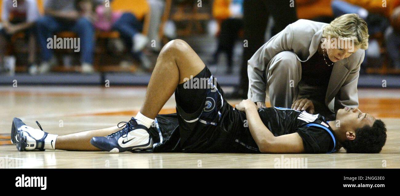 Georgetown's Drew Hall is checked by trainer Lorry Michel after he ...