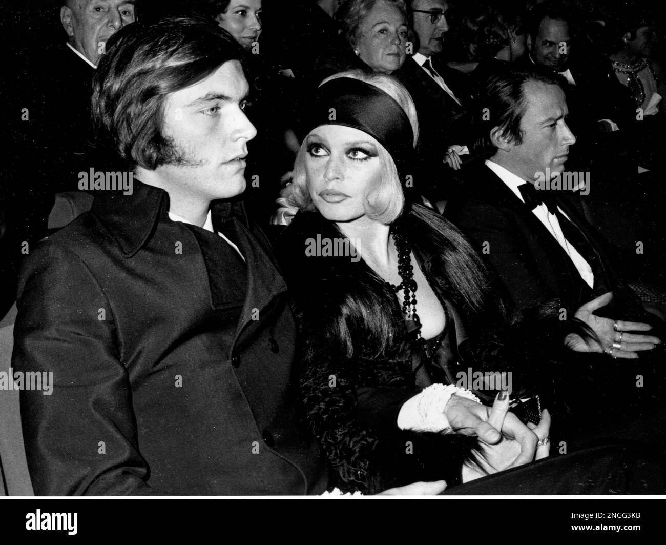 French actress Brigitte Bardot sits hand in hand with her friend, actor ...