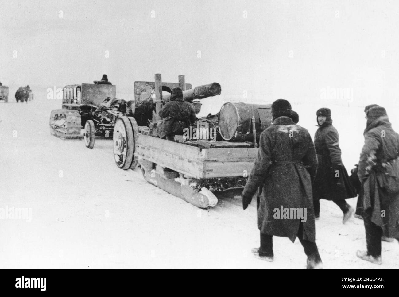 A Soviet army tractor pulls a sled with equipment and a large gun, as ...