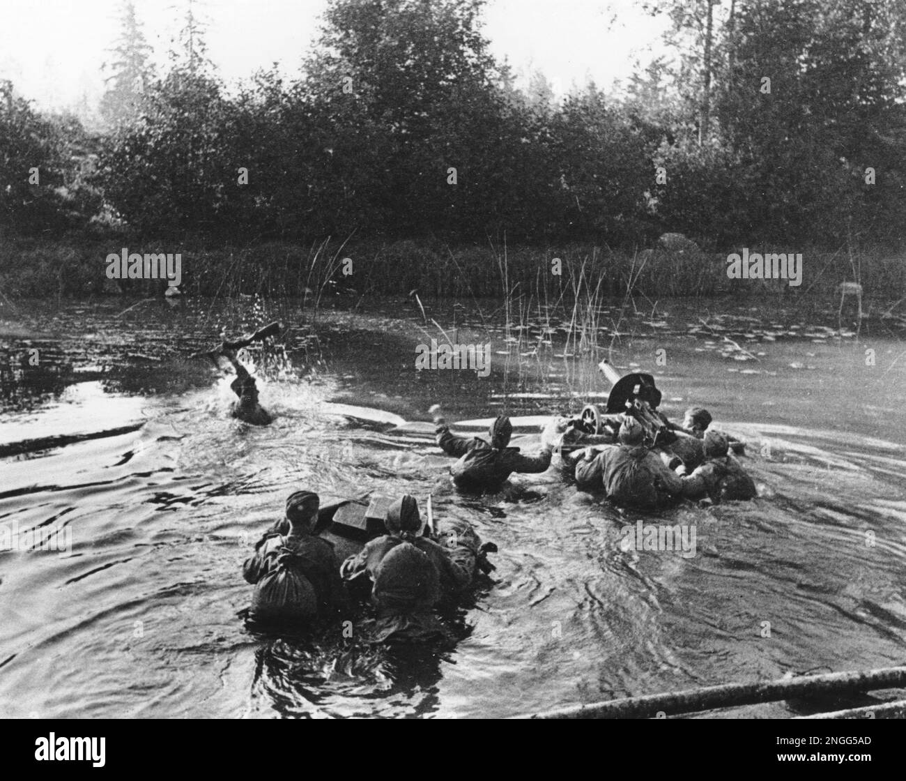 A Soviet machine gun crew is seen as they cross a river along the ...