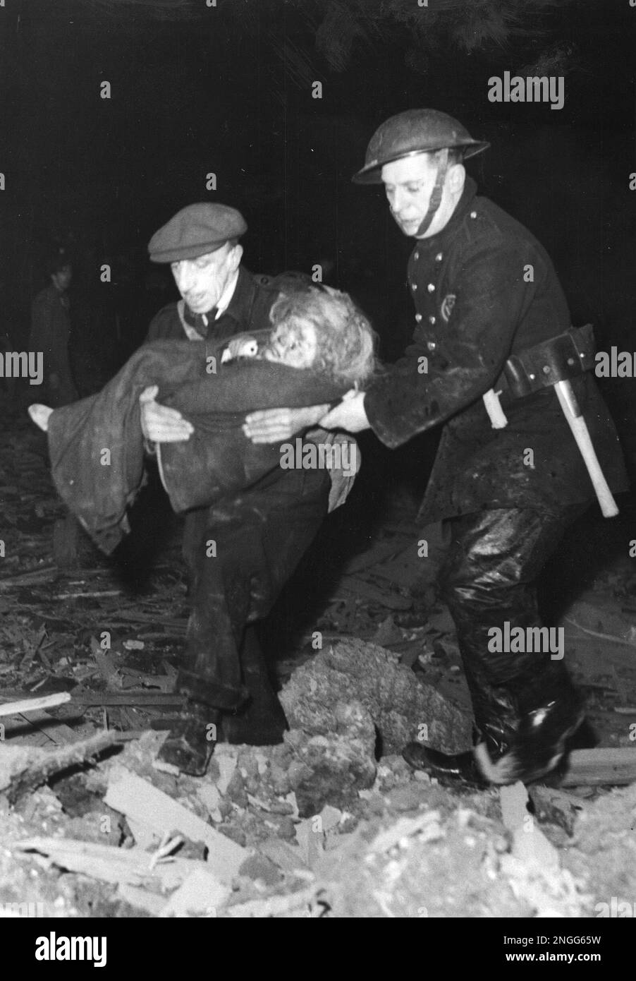 A London firefighter and a civilian carry a wounded child through ...