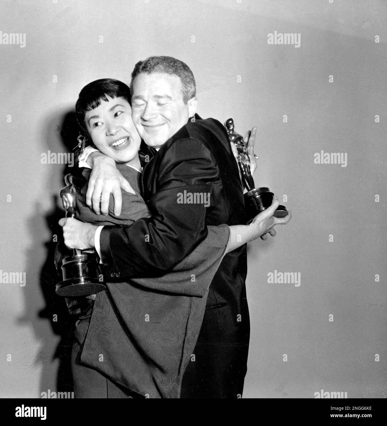 Miyoshi Umeki and Red Buttons hug each other with their Oscars at the ...