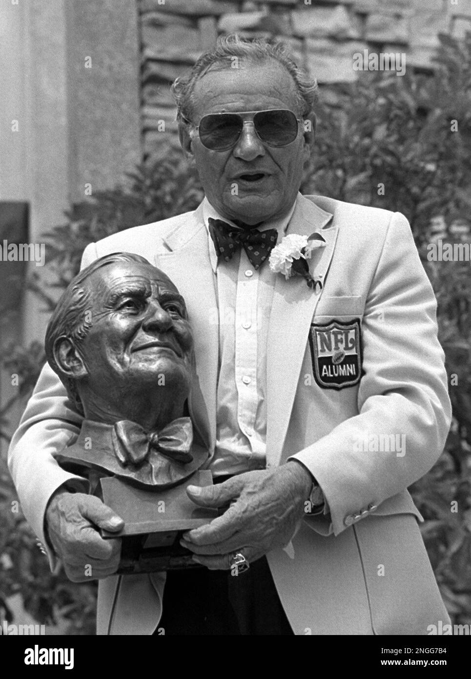 Former NFL coach Sid Gillman holds his bust after being officially ...