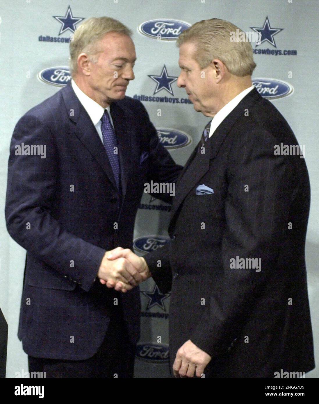 Dallas Cowboys owner Jerry Jones, left, shakes hands with his new head ...