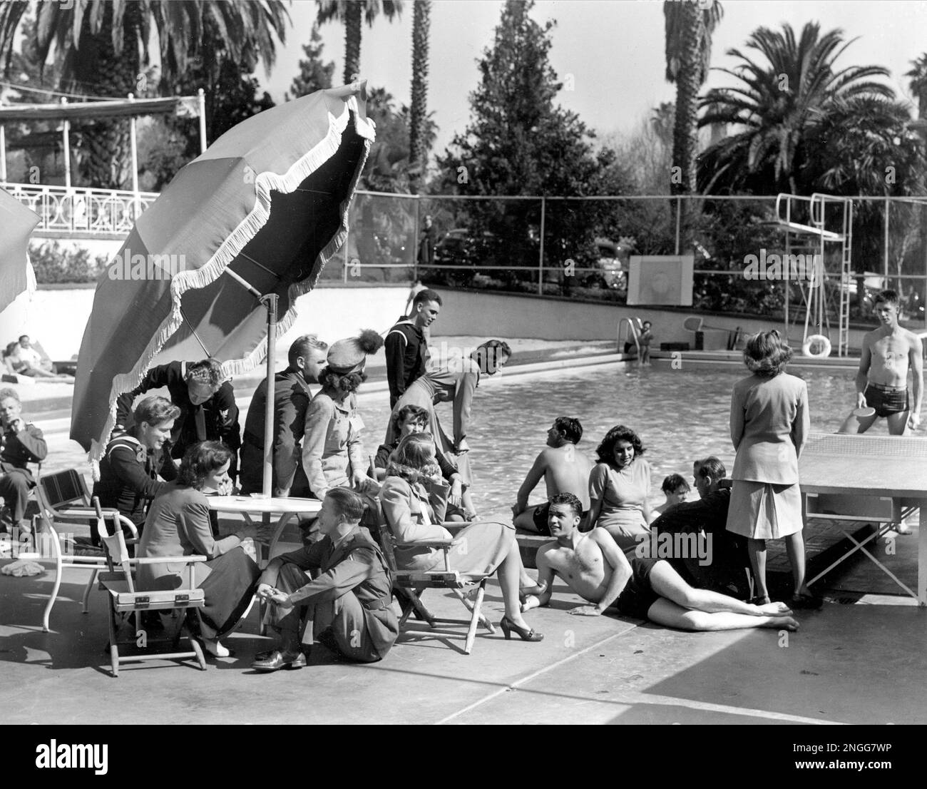 Soldiers and sailors relax poolside at the Sand and Pool Club during a ...