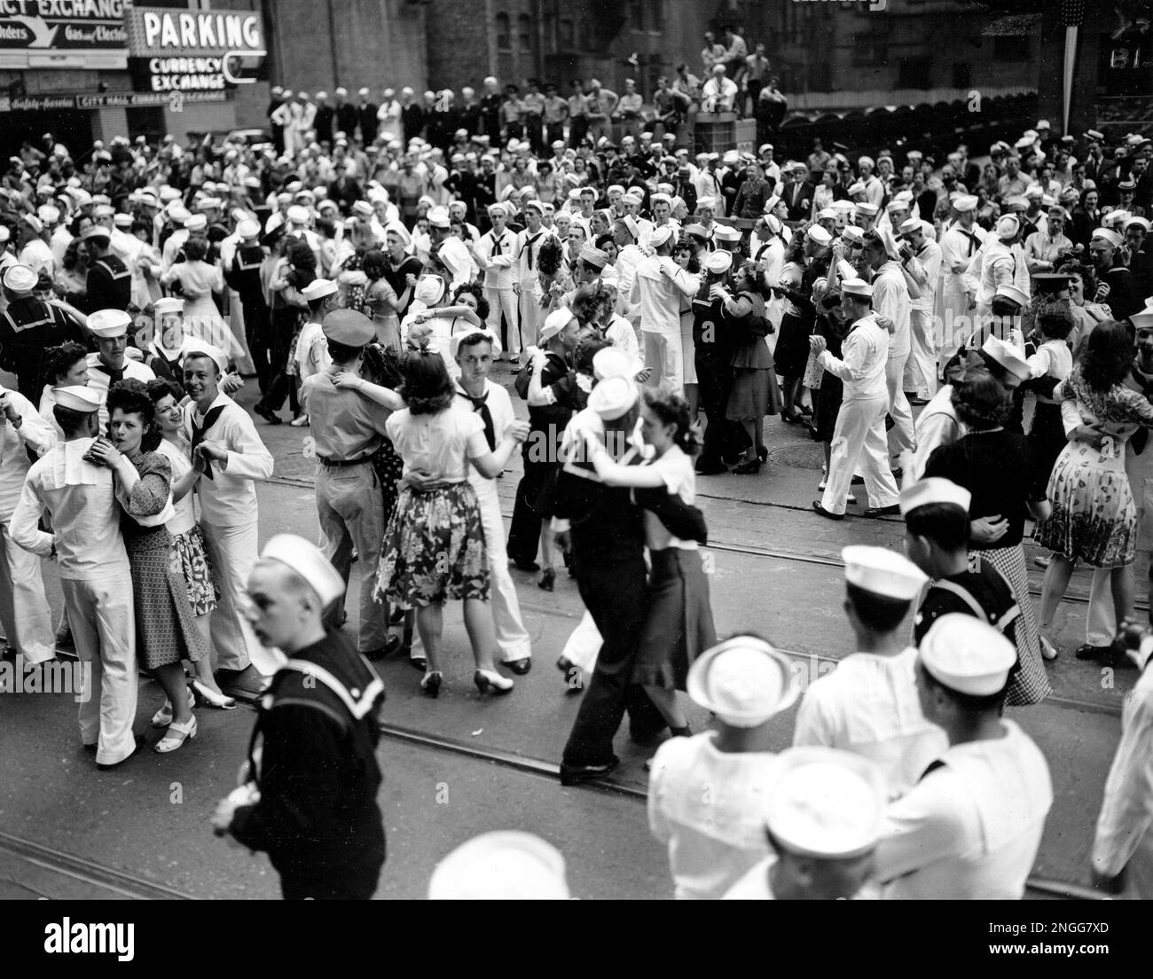 Members of the Army, Navy and Marines dance with young women who serve ...