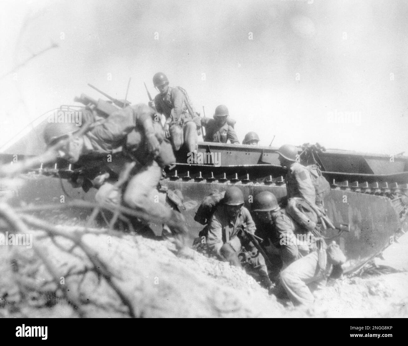 U.S. Marines take cover behind an amphibious tractor, during the ...
