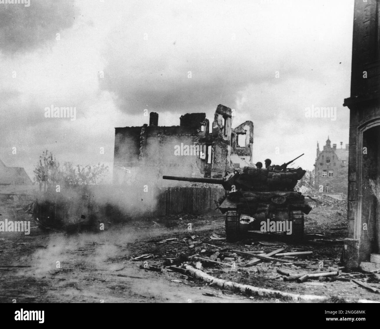 An American tank destroyer is seen patrolling through a street littered ...
