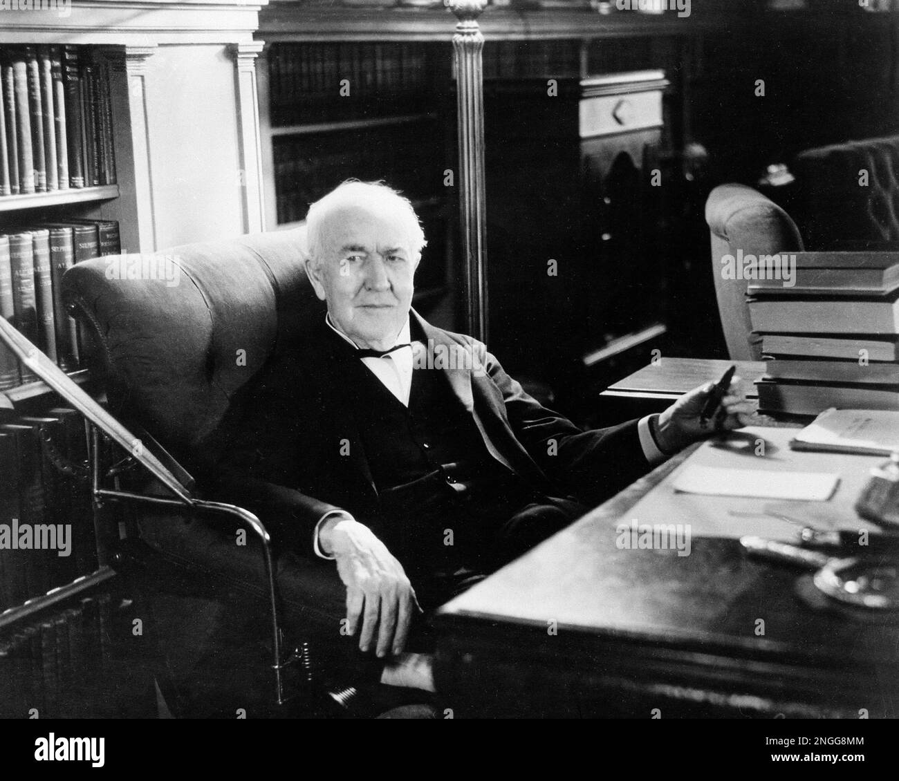 Thomas Alva Edison sits at his desk in the family living room at the ...