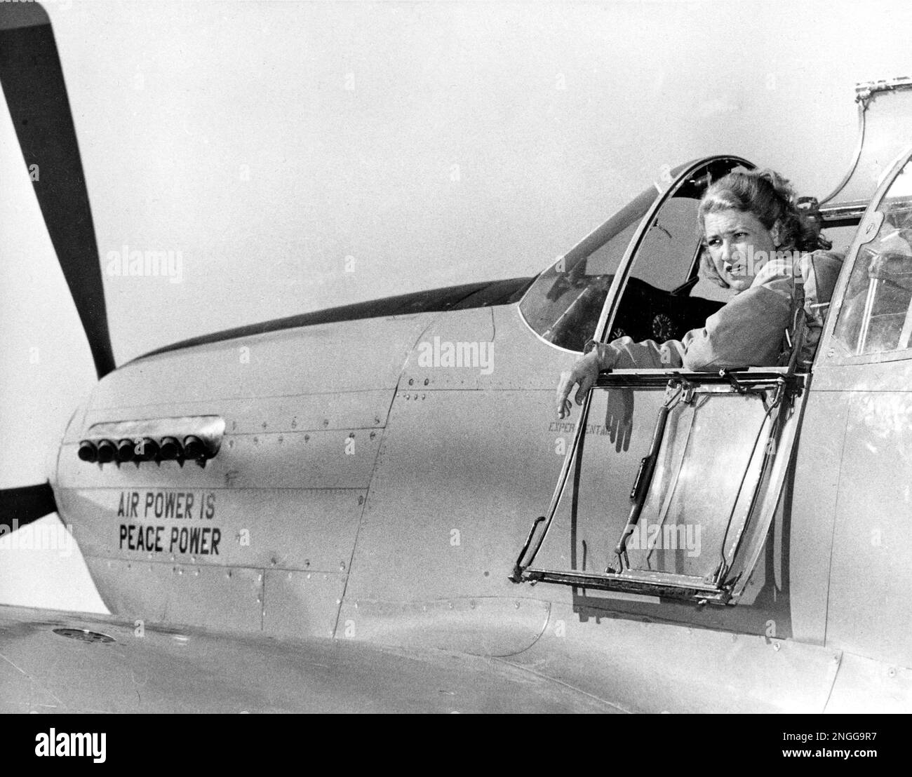 Jacqueline Cochran, racing pilot, looks from the cockpit of her P-51 ...