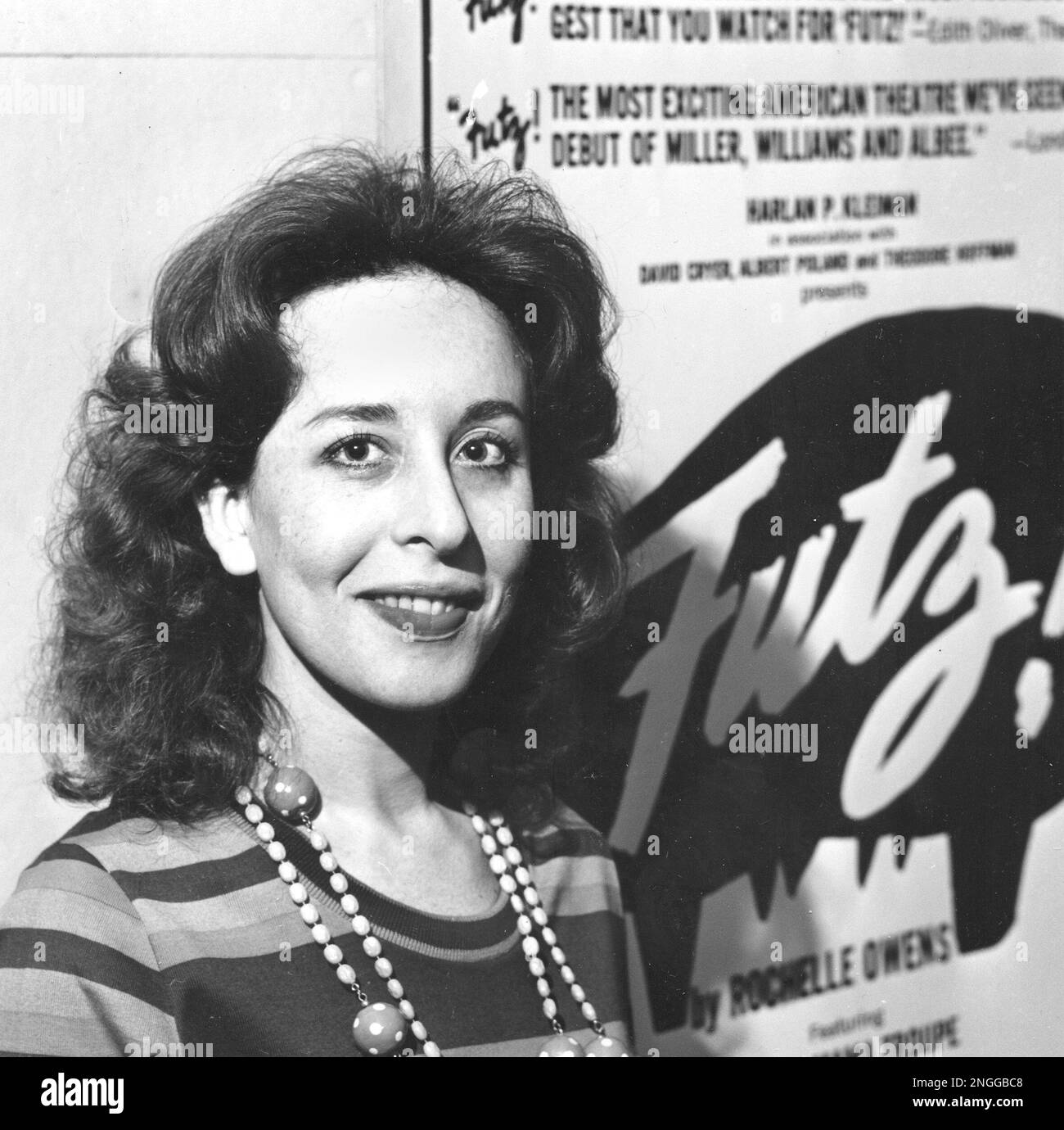 Playwright Rochelle Owens poses in front of a poster advertising her ...