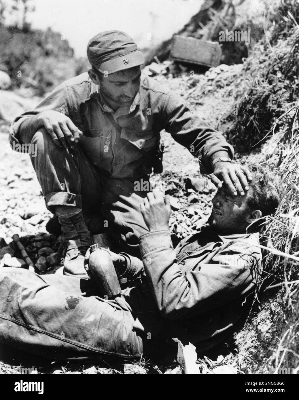 A U.S. Marine comforts a comrade, who witnessed the death of his buddy ...