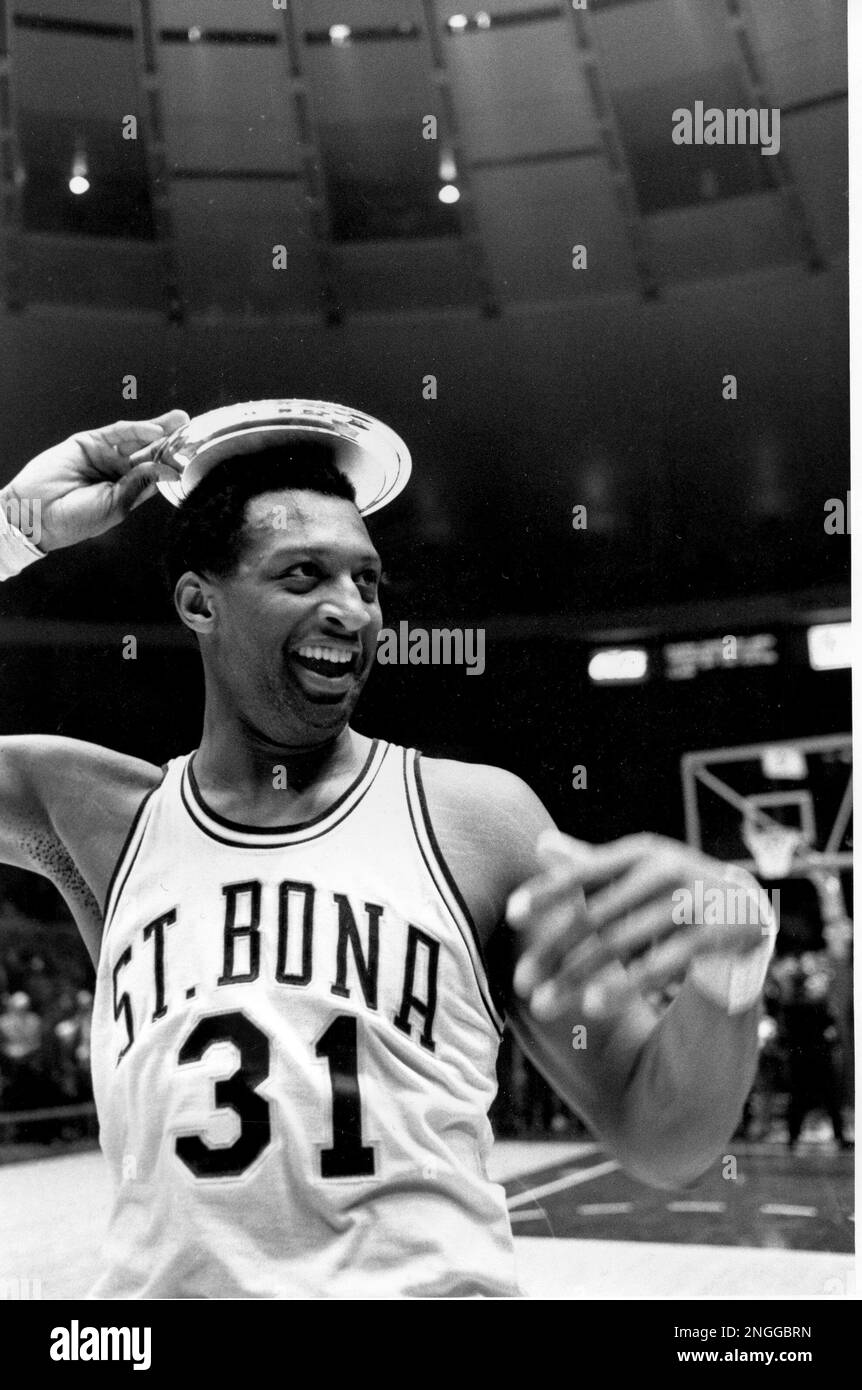 Bob Lanier (31) of St. Bonaventure puts his MVP trophy on his head ...