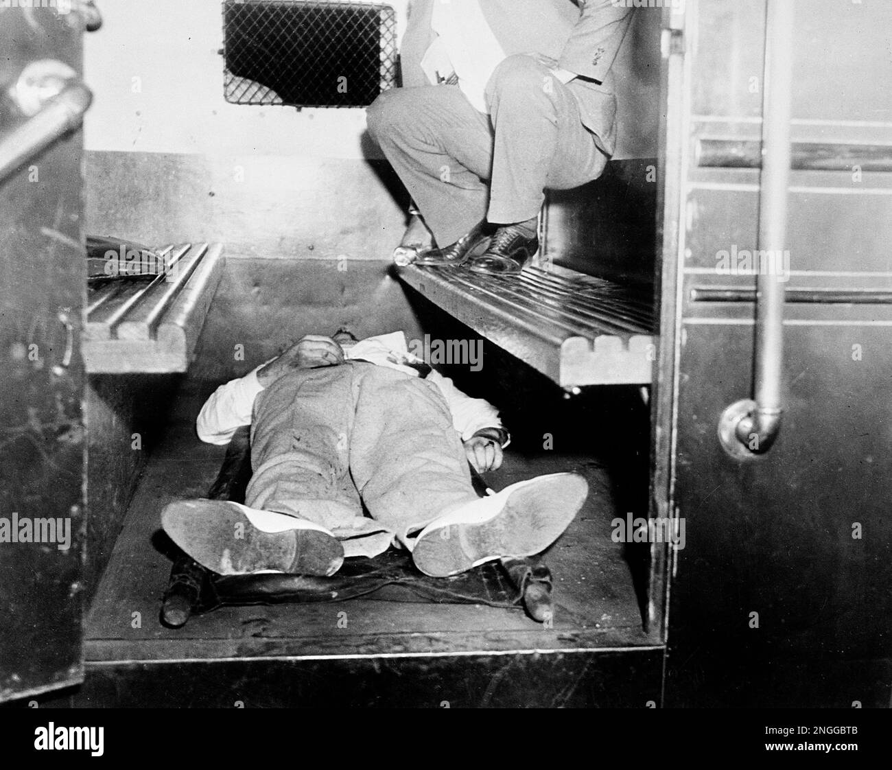 The body of slain outlaw John Dillinger is placed in a police wagon ...