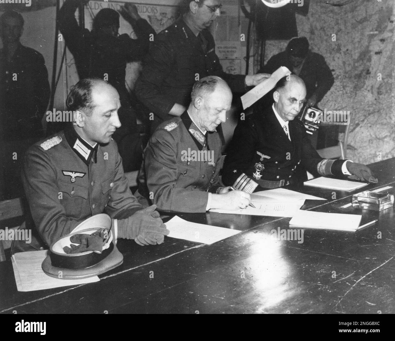 General Alfred Jodl, center, signs the unconditional surrender of all ...