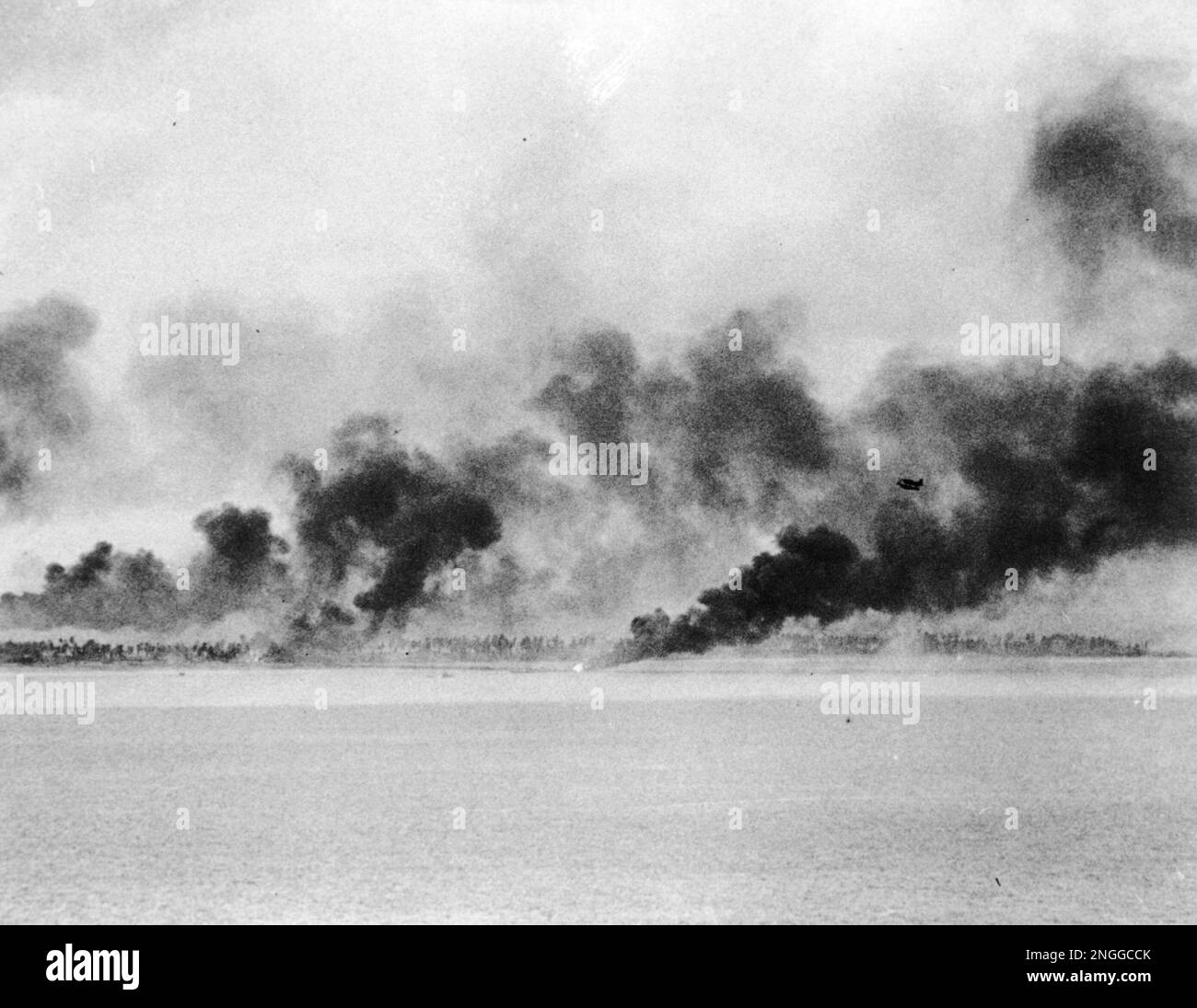 Black smoke rises from Betio islet after a U.S. air raid against enemy ...