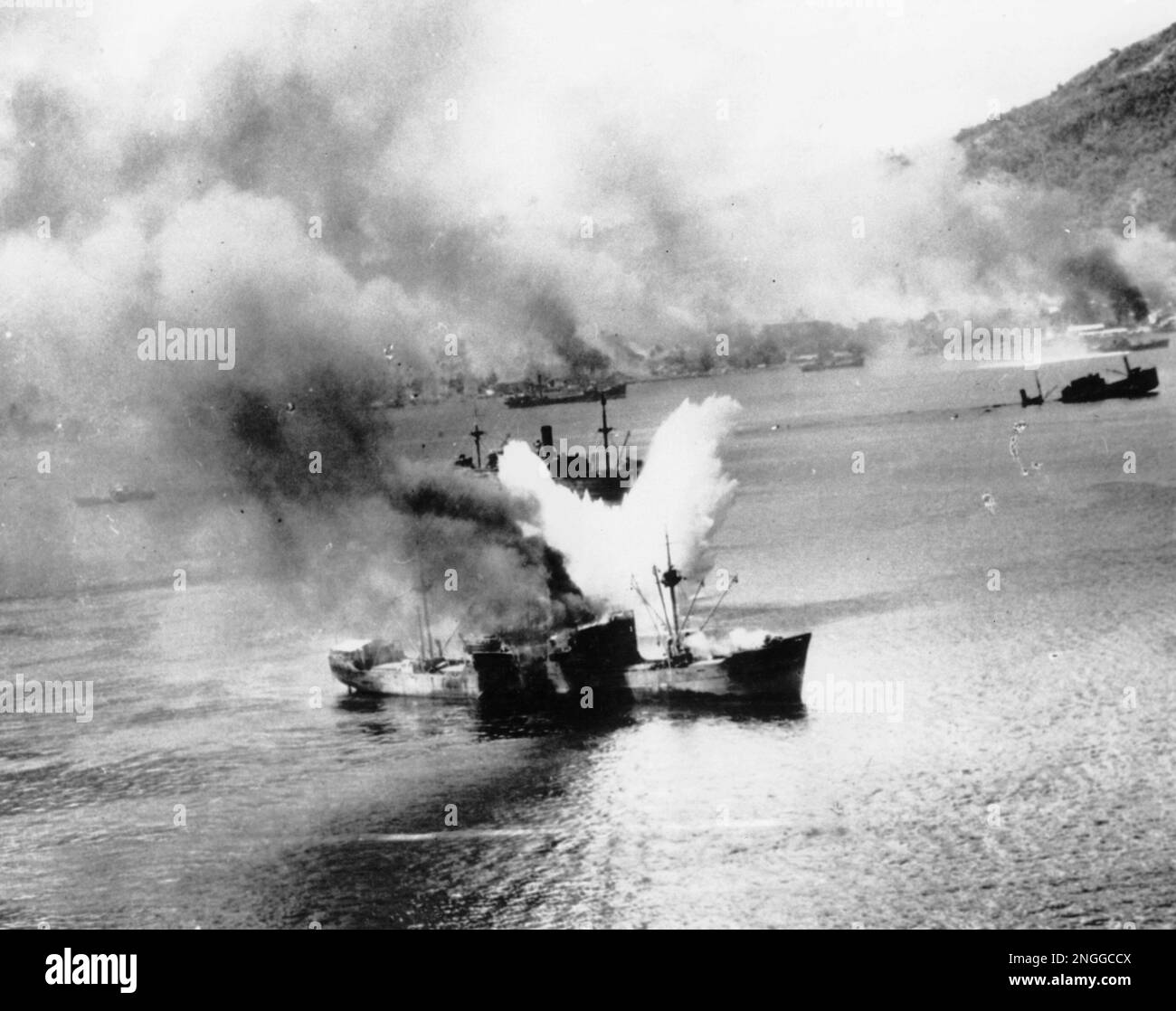 A Japanese vessel takes a hit amidships in Rabaul harbor, New Britain ...