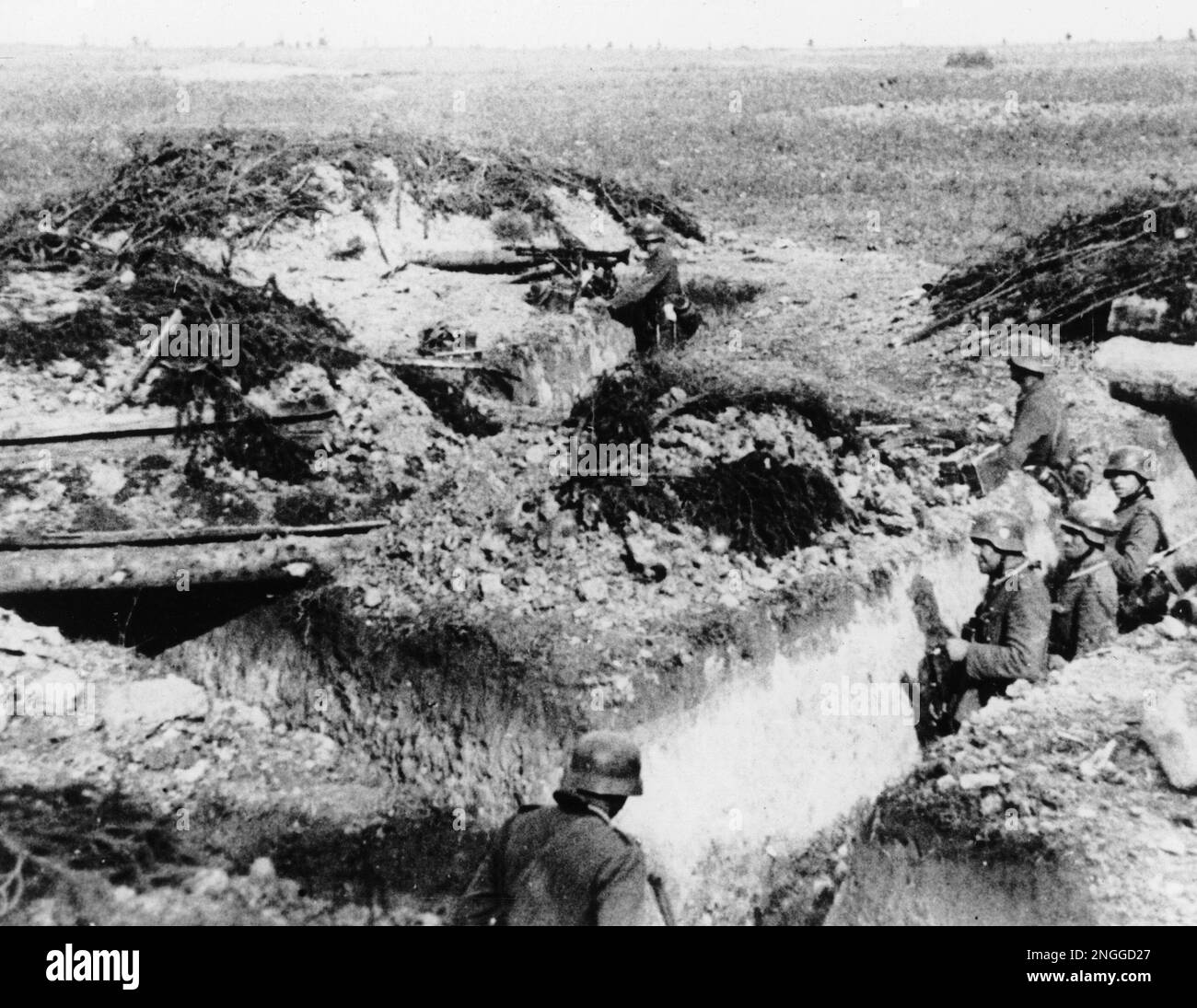 German soldiers stand in the trenches they captured from retreating ...