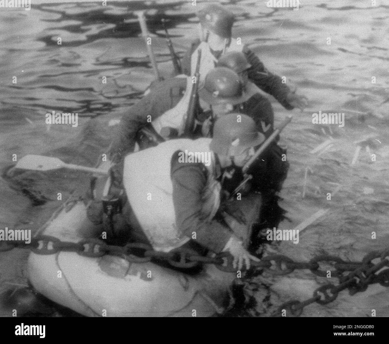 German soldiers make a landing from a rubber raft near the Maas Bridge ...