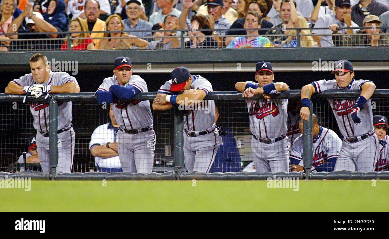 Members of the Atlanta Braves watch the final moments of the eighth ...
