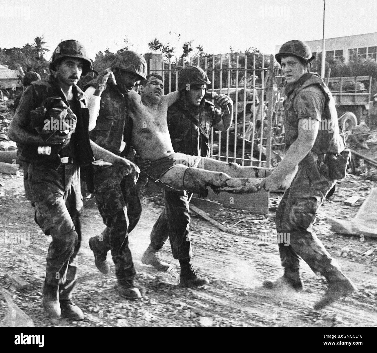 A U.S. Marine, his leg deeply torn from the explosion that destroyed a ...