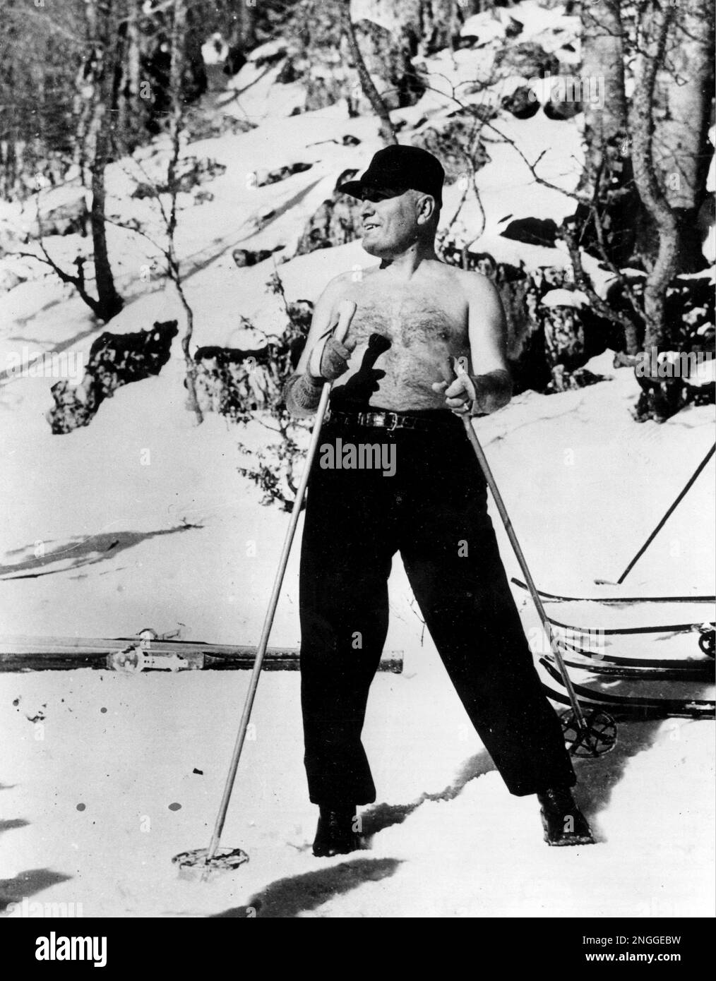 Italy's Premier Benito Mussolini, stripped to the waist, rests between ...