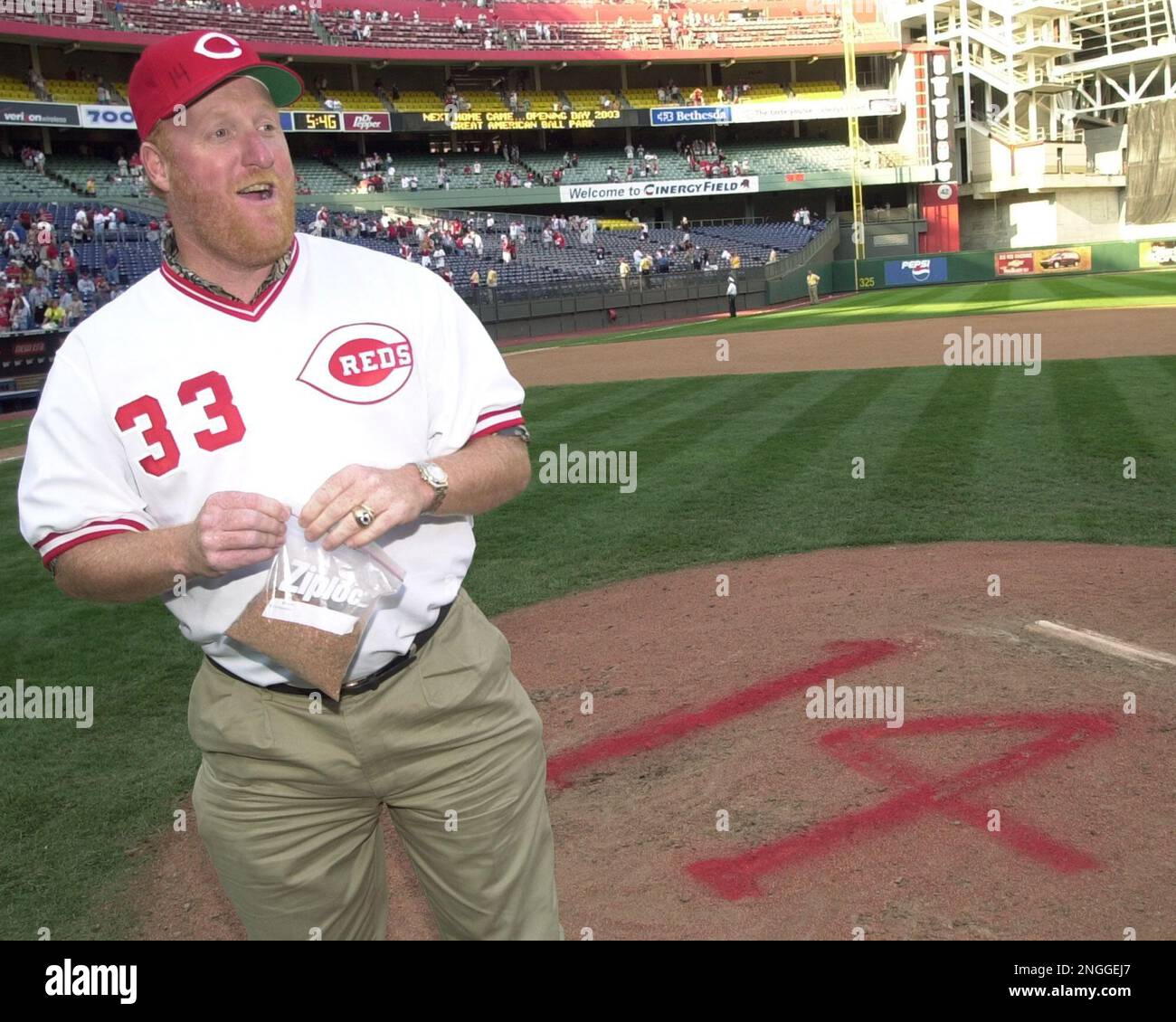 Former Cincinnati Reds pitcher Ron Robinson carries away a bag of dirt ...