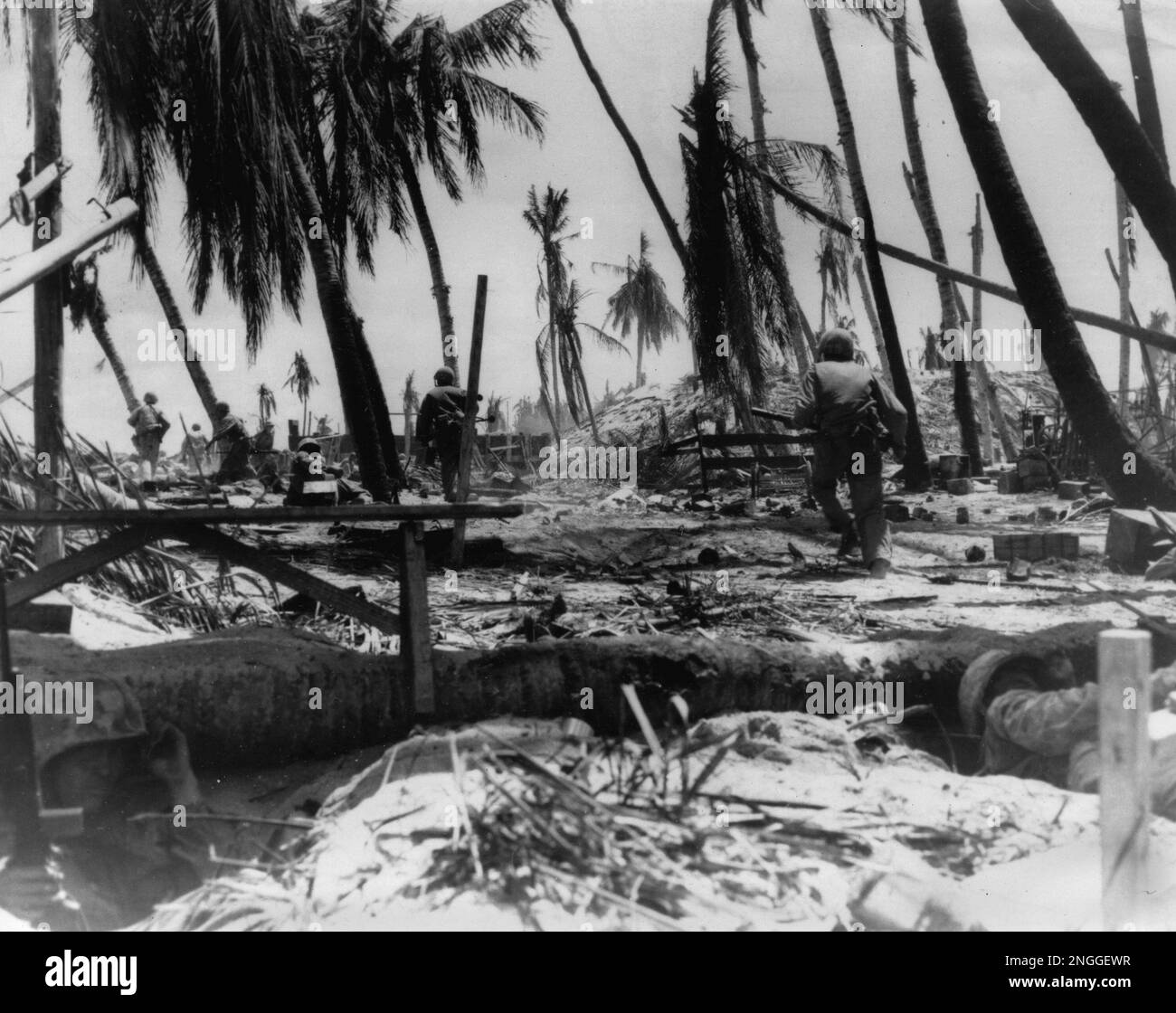 U.S. Marines charge a hill on Tarawa in the early stages of the battle ...
