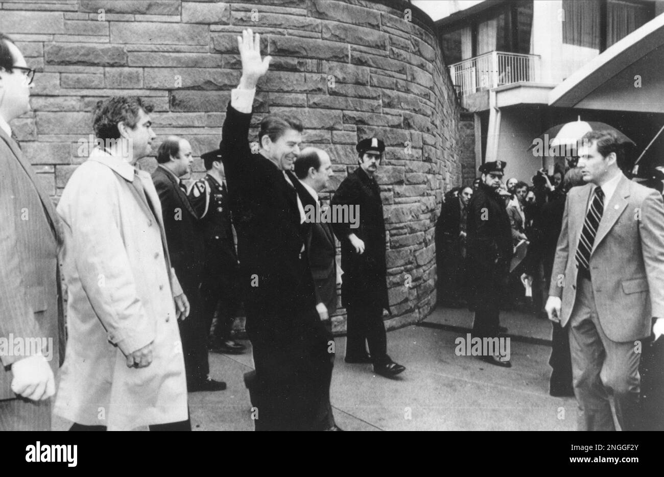 U.S. President Ronald Reagan waves just before he is shot outside the ...