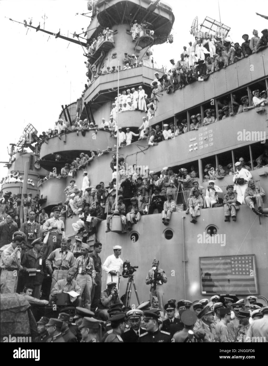 Spectators and photographers pick vantage positions on the deck of the ...