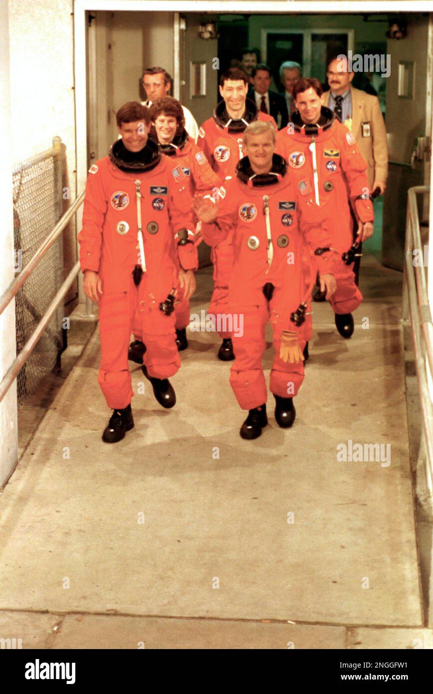 Crew members of STS-54 leave the Operations and Checkout Building at the Kennedy Space Center ...