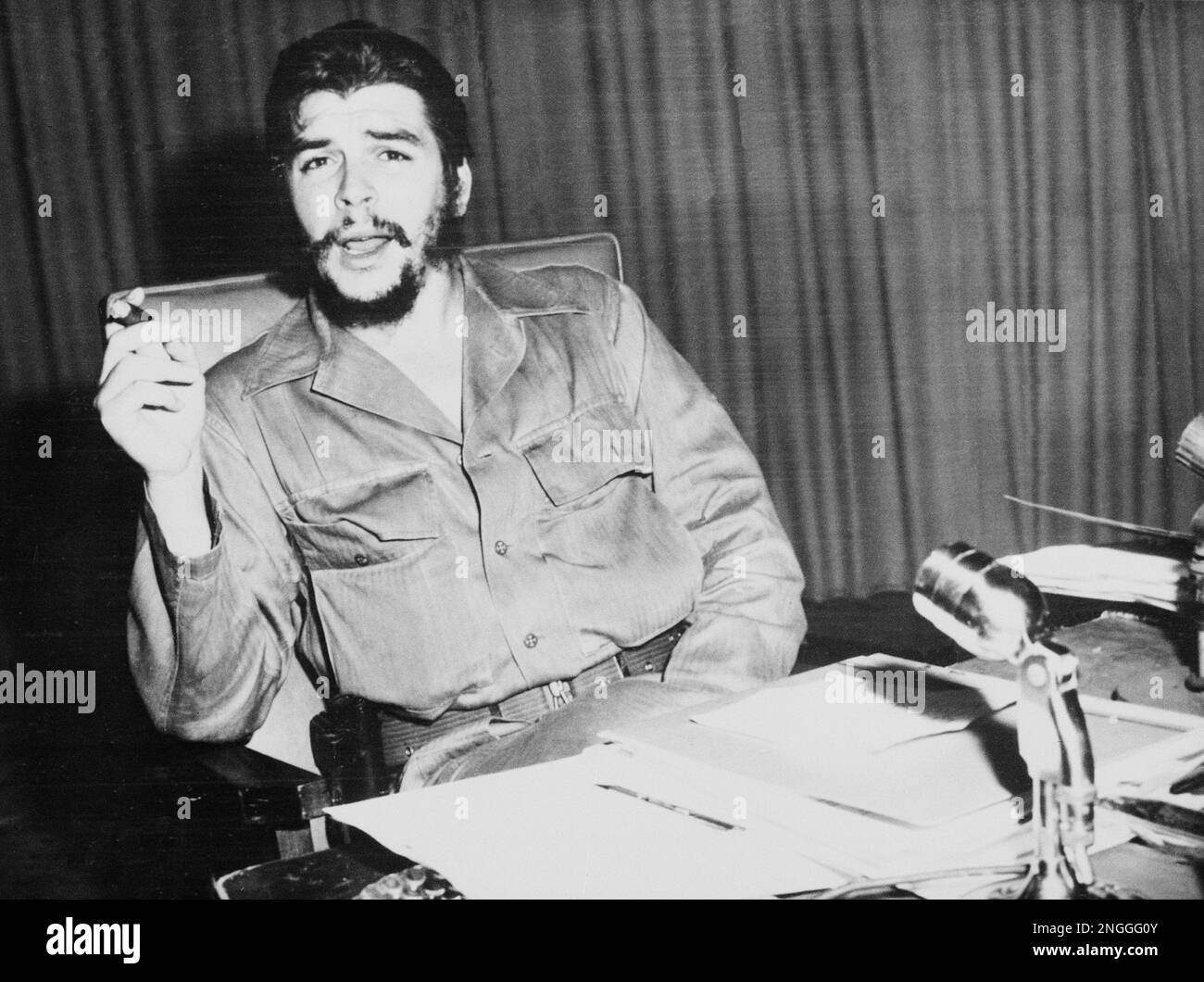 Major Ernesto "Che" Guevara is shown at his desk with cigar in hand in ...