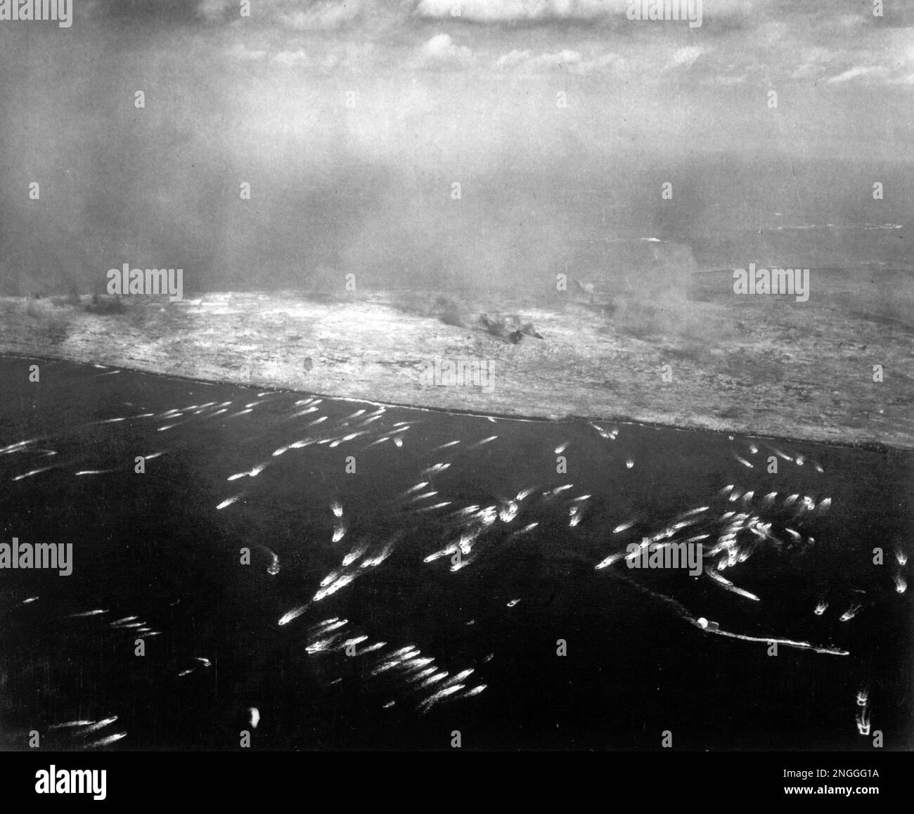 An armada of landing ships brings U.S. troops to the smoke-enveloped ...